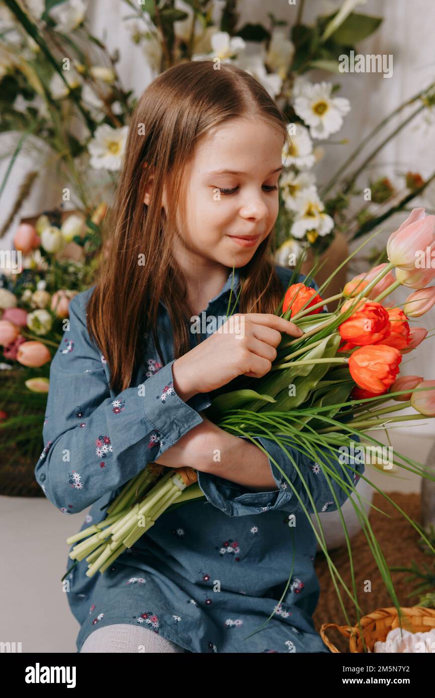 Two girls in a beautiful Easter photo zone with flowers, eggs, chickens ...