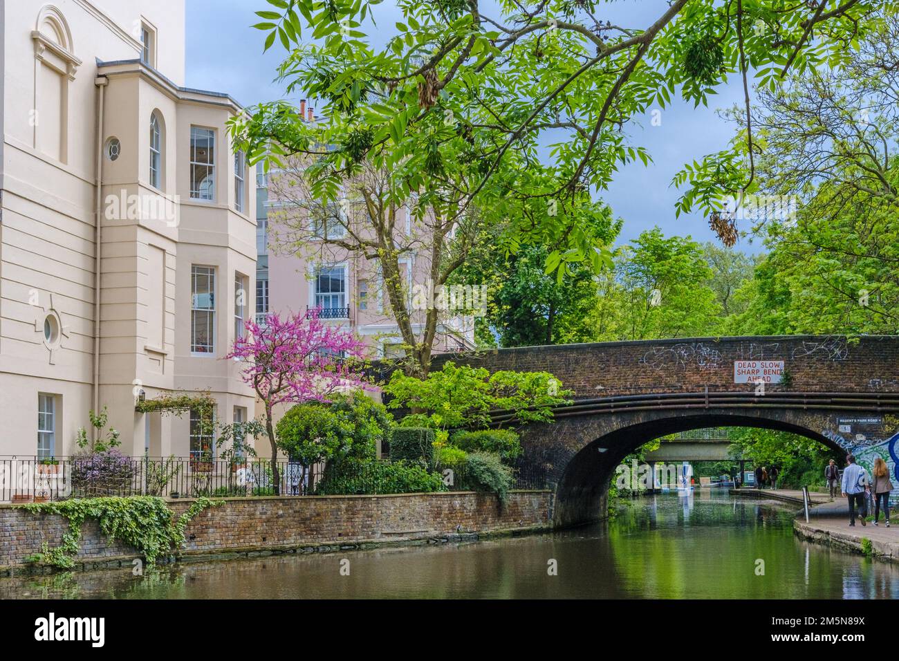 Regent’s Park Road bridge over Regent’s Canal, with people walking on ...