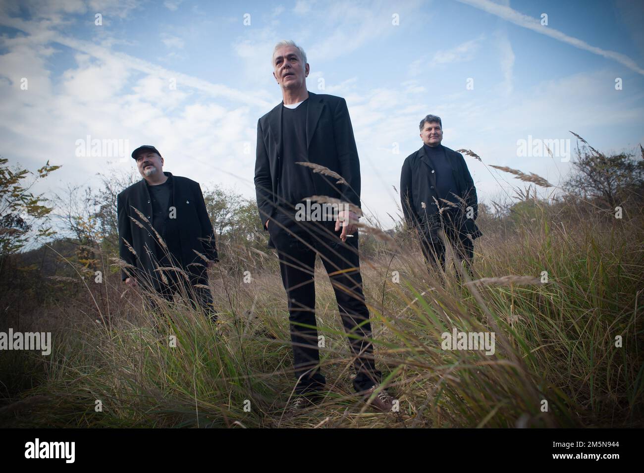 Portrait of urban and handsome fashionable artist guy pose in black ...