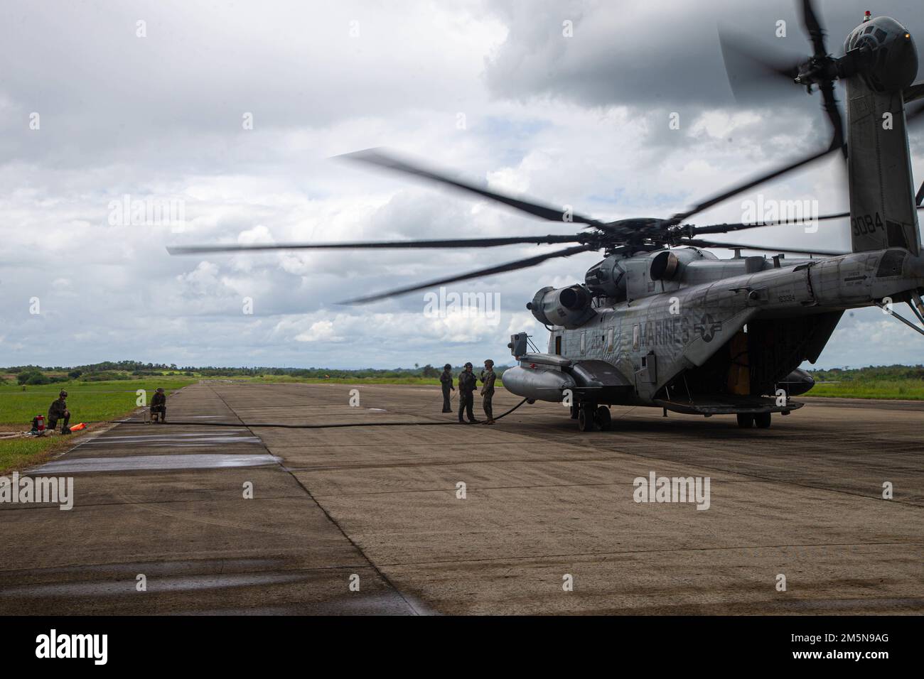 U.S. Marines assigned to Marine Heavy Helicopter Squadron 466 (HMH-466), refuel a CH-53E Super ...