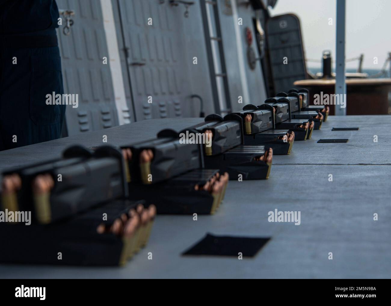 ARABIAN GULF (March 29, 2022) M9 pistol magazines rest on a table prior ...