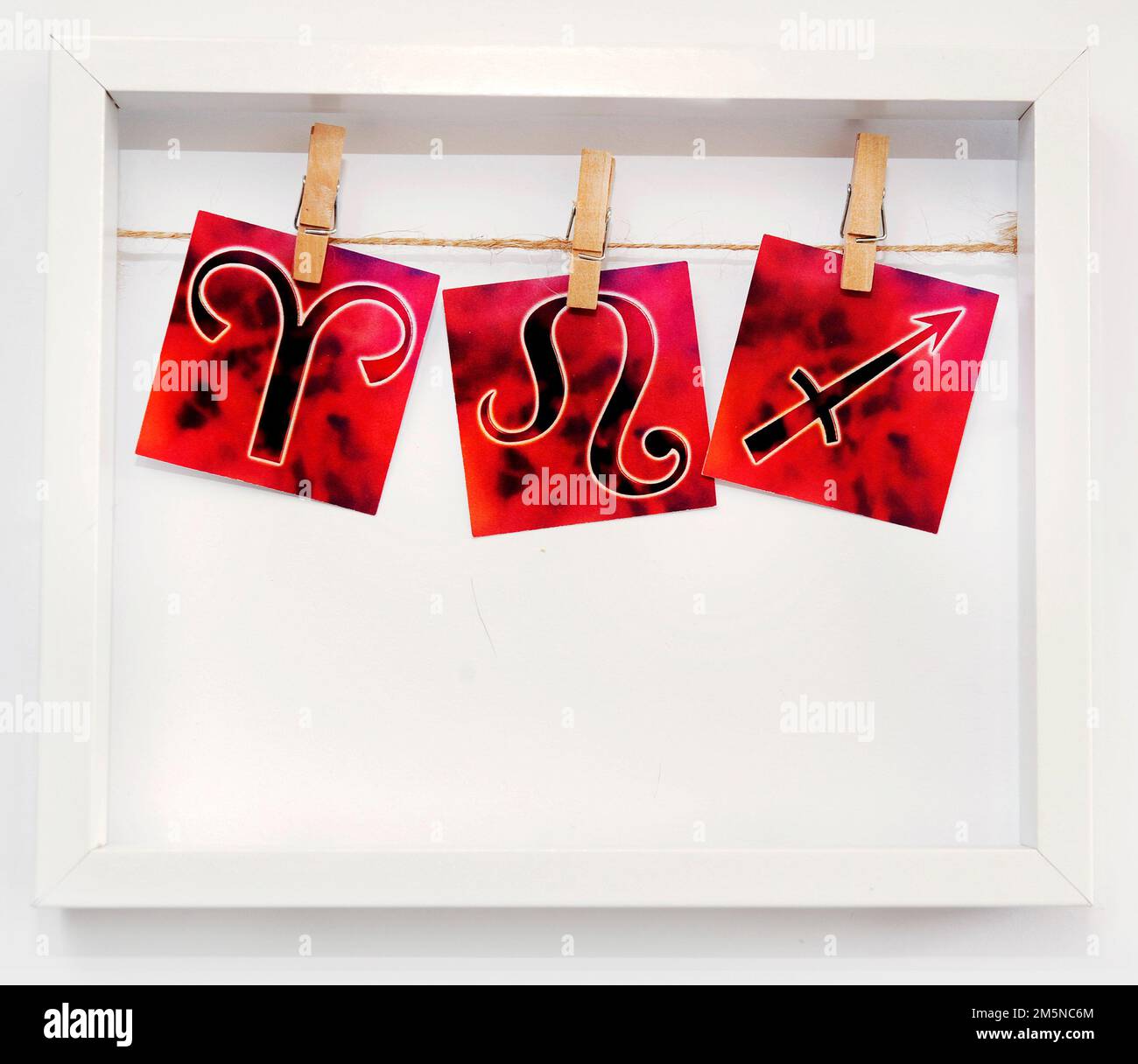 cards of the signs of fire hanging on a rope with clothespin Stock ...