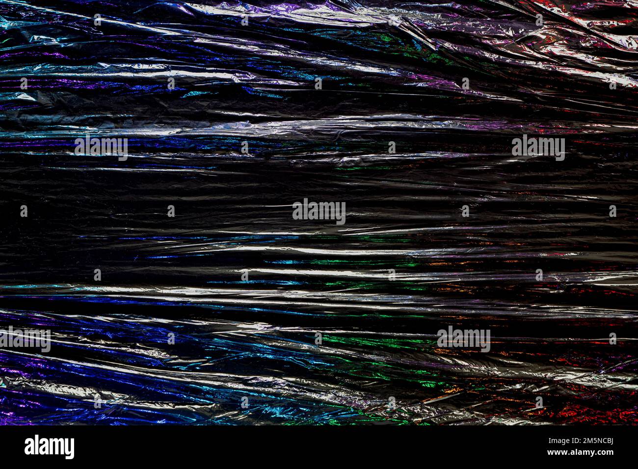 Black color plastic wrap background. Dark crumpled wrinkled plastic ...