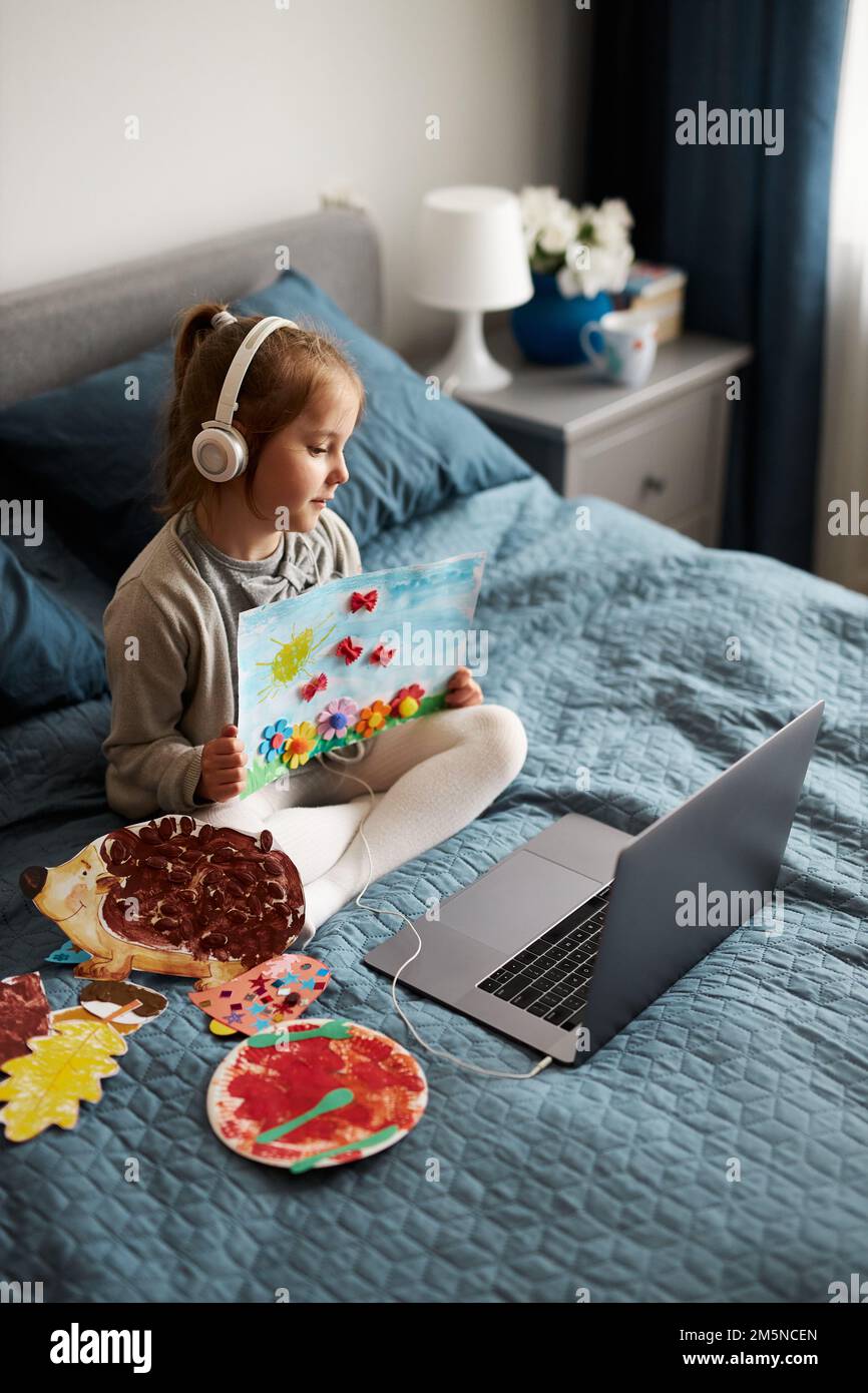 Little girl preschooler learning online showing her works drawings done ...