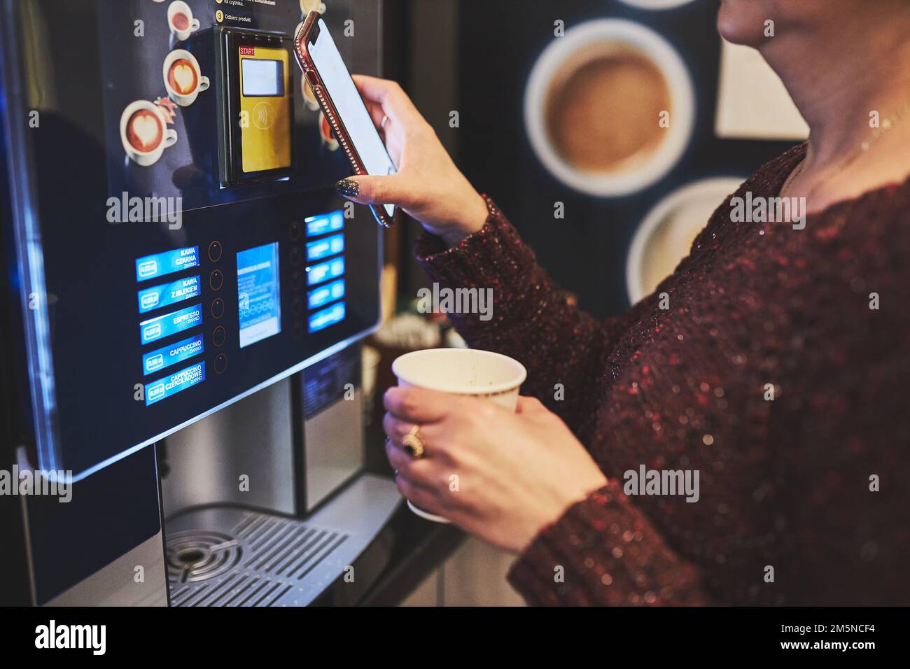Woman paying for product at vending machine using contactless method of ...
