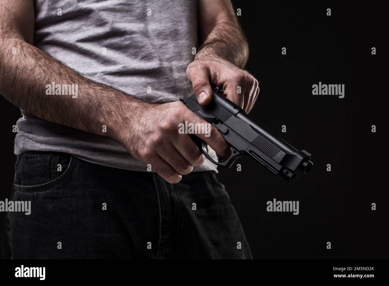 Killer with gun on black background at the studio Stock Photo - Alamy