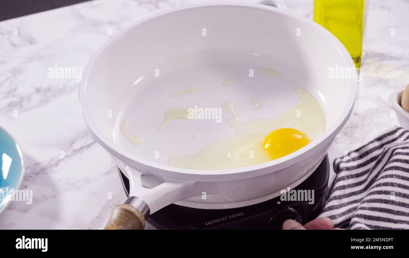 Frying farm fresh eggs Stock Photo - Alamy