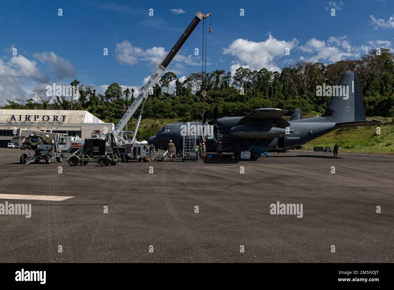 U.S. Airmen with the 353rd Special Operations Wing repair an MC-130J ...