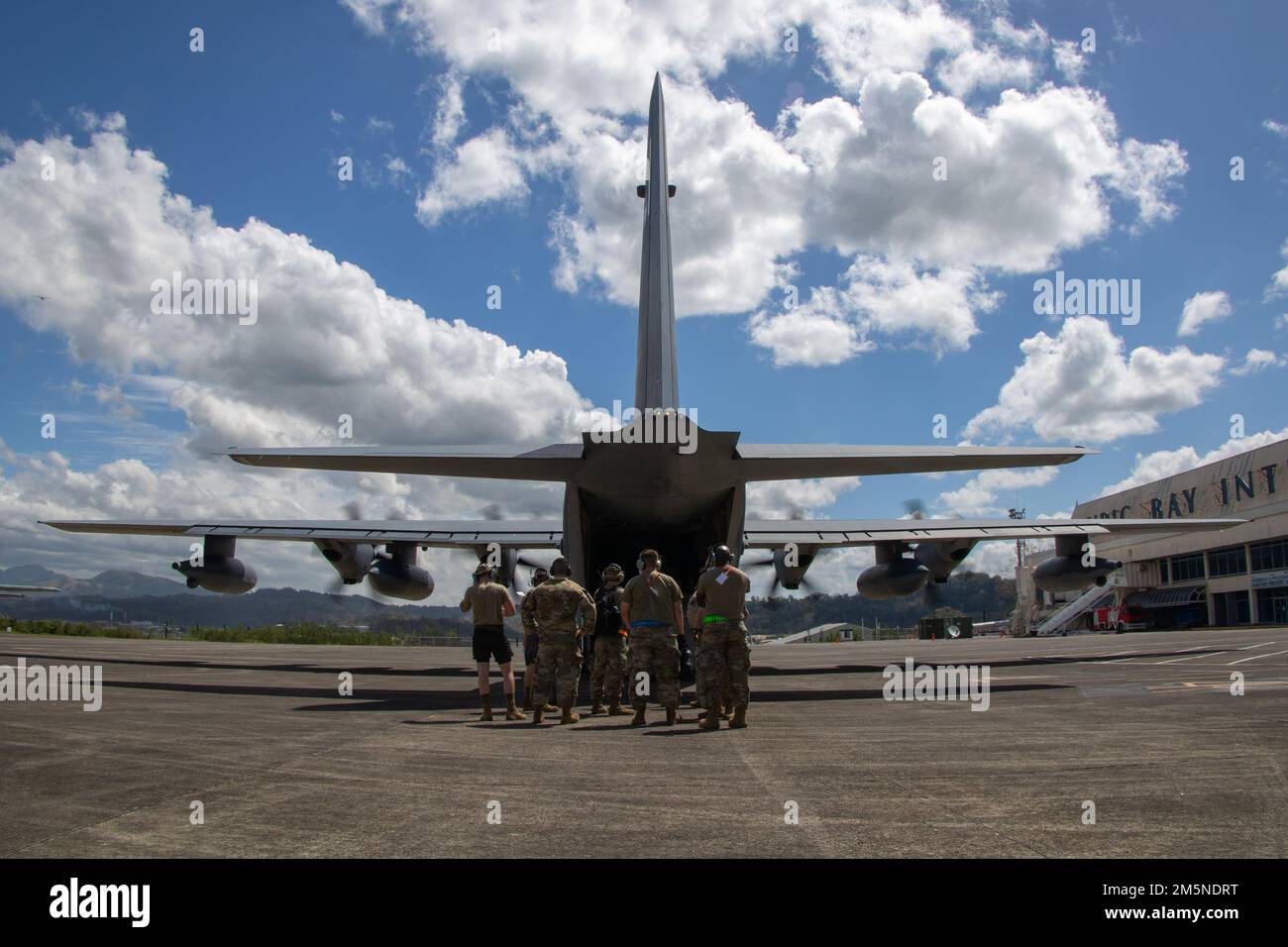 U.S. Airmen with the 353rd Special Operations Wing begin unloading an ...