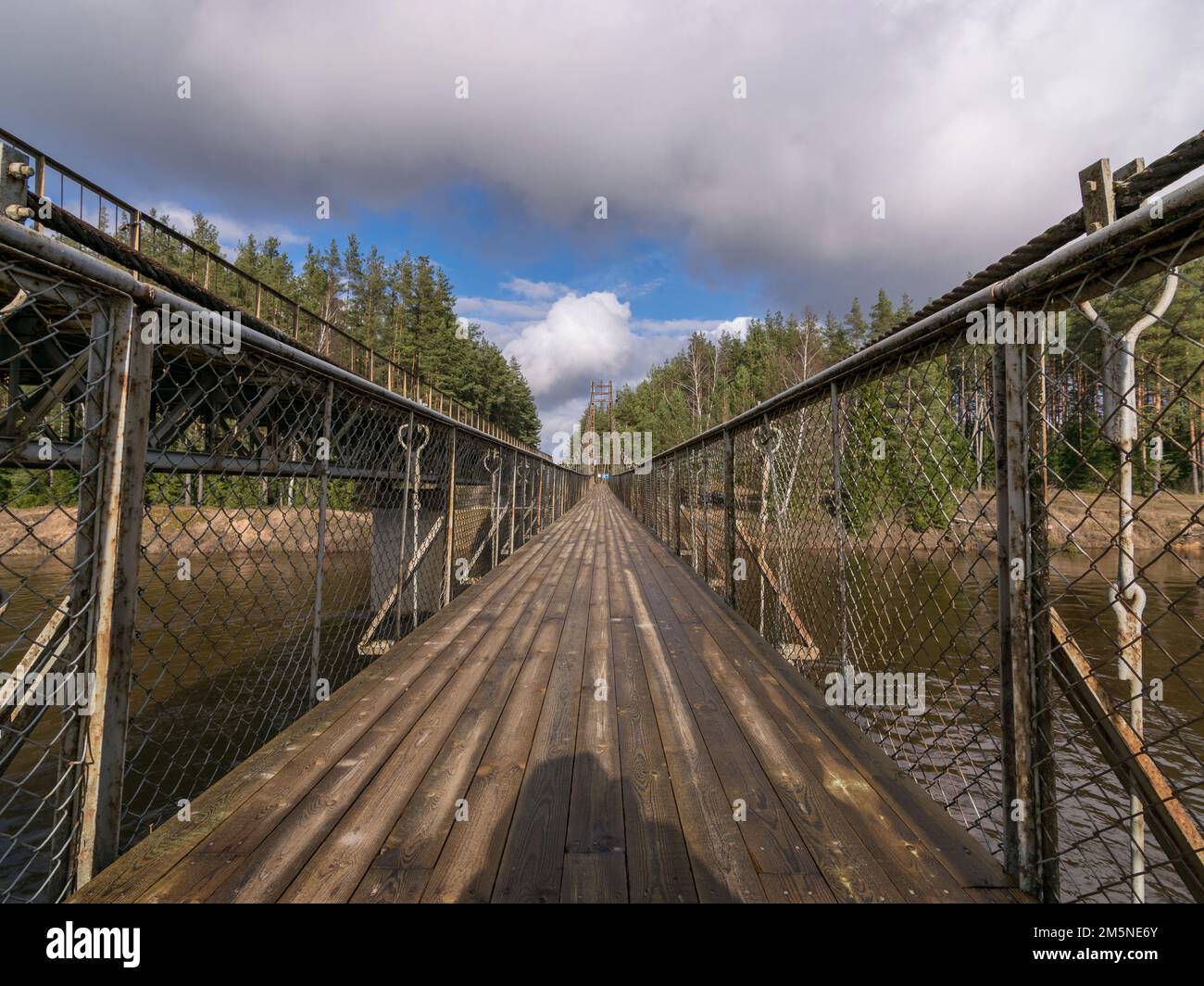 beautiful spring landscape with a cable bridge over the river. River ...