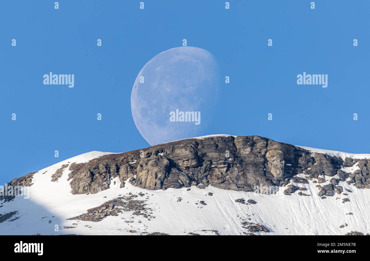 Crescent moon rises over mountain Stock Photo - Alamy