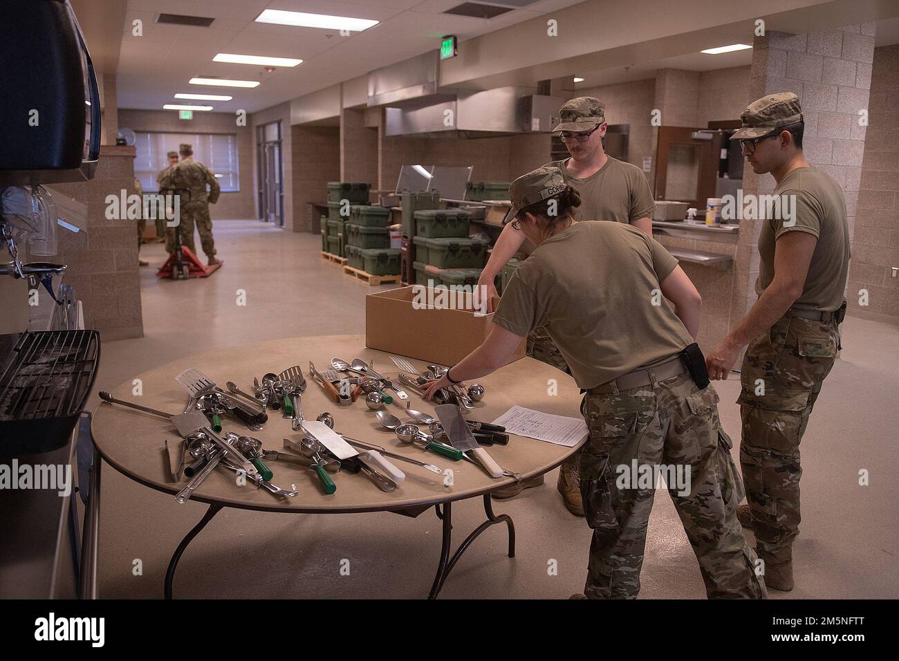 Sgt. Holly Coriell puts together serving tools to send with the meals ...