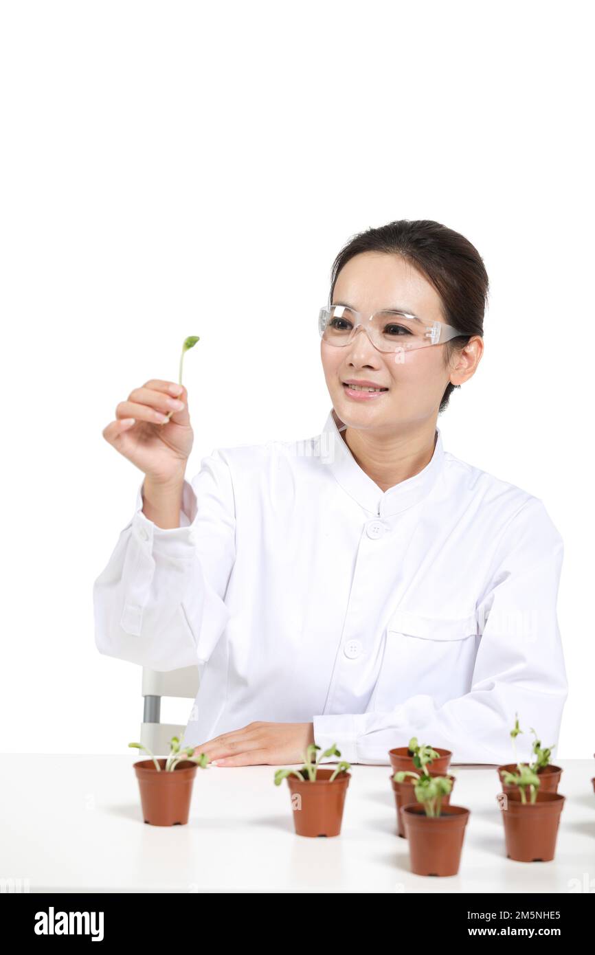 Young women scientists study looked at plants Stock Photo - Alamy