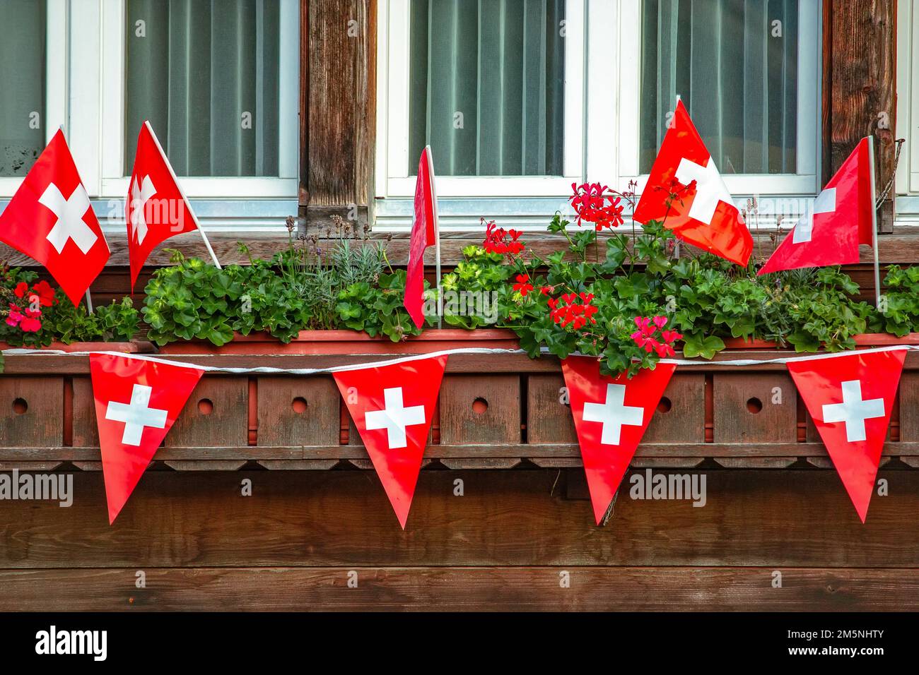 Old traditional wooden window with Switzerland flags Stock Photo - Alamy