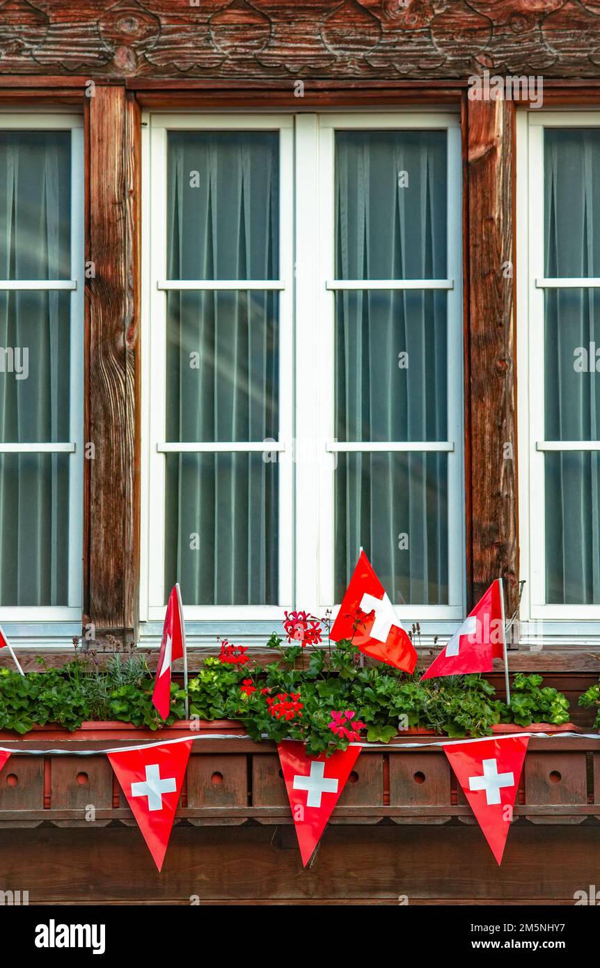 Old traditional wooden window with Switzerland flags Stock Photo - Alamy