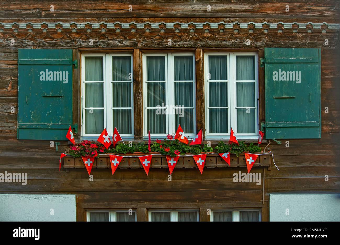 Old traditional wooden window with Switzerland flags Stock Photo - Alamy