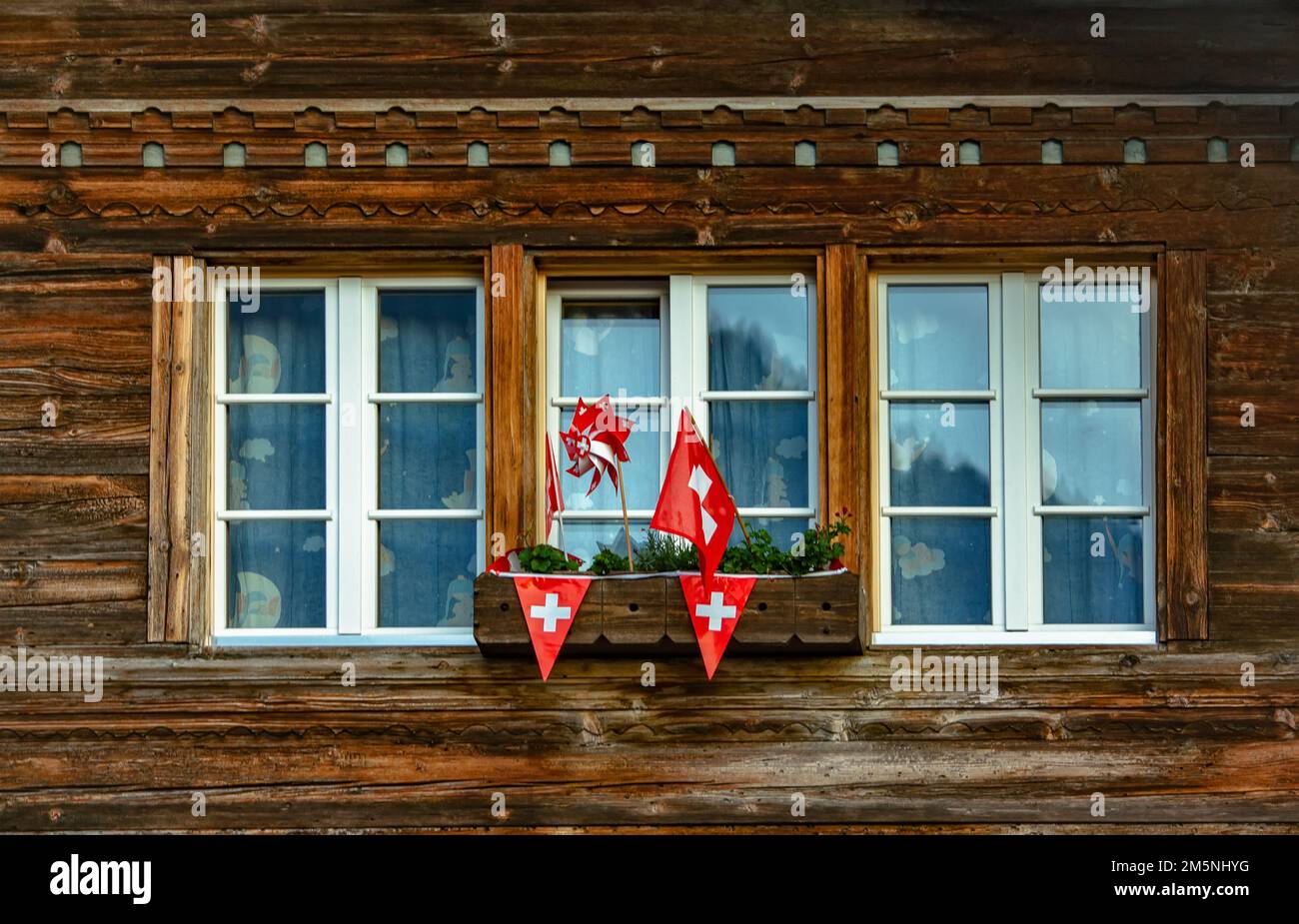 Old traditional wooden window with Switzerland flags Stock Photo - Alamy