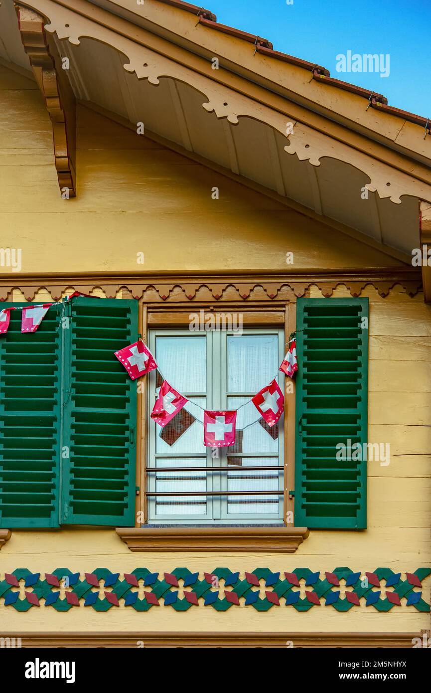 Old traditional wooden window with Switzerland flags Stock Photo - Alamy