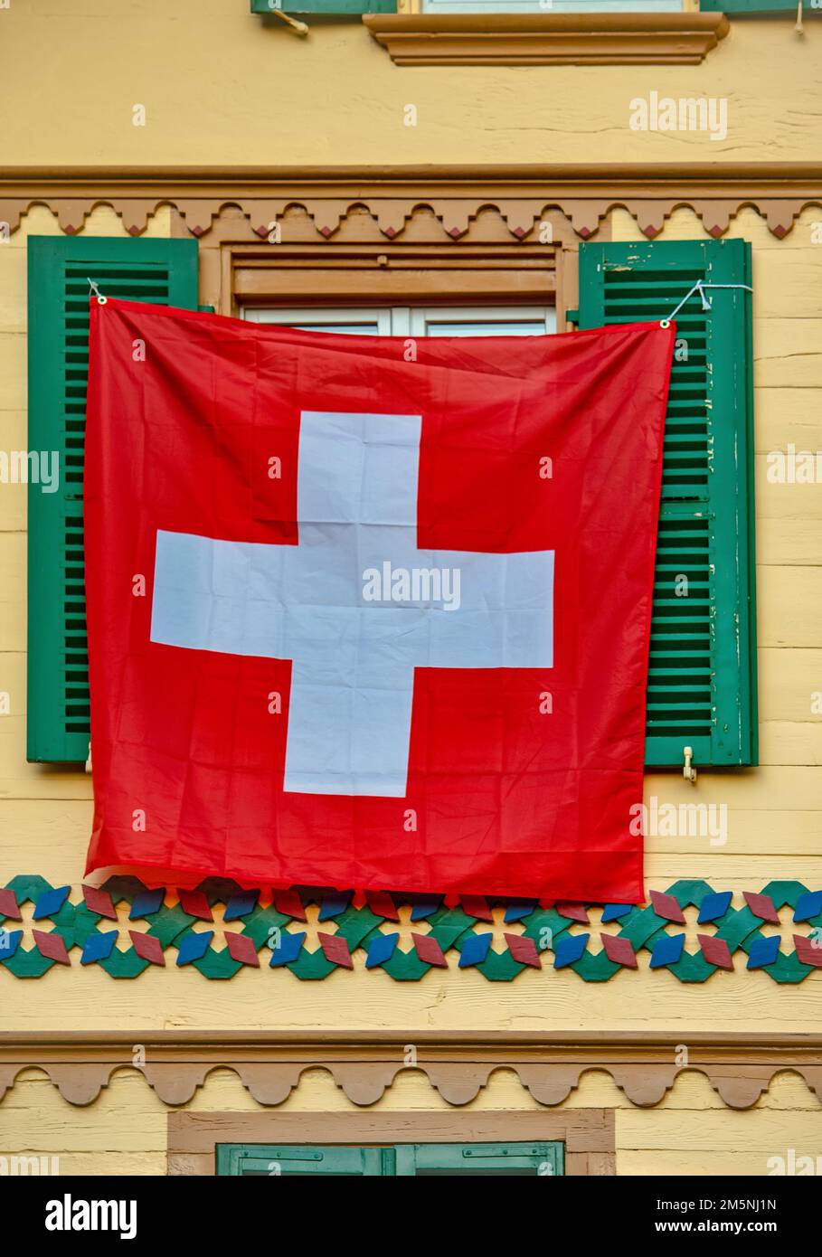 Old traditional wooden window with Switzerland flags Stock Photo - Alamy