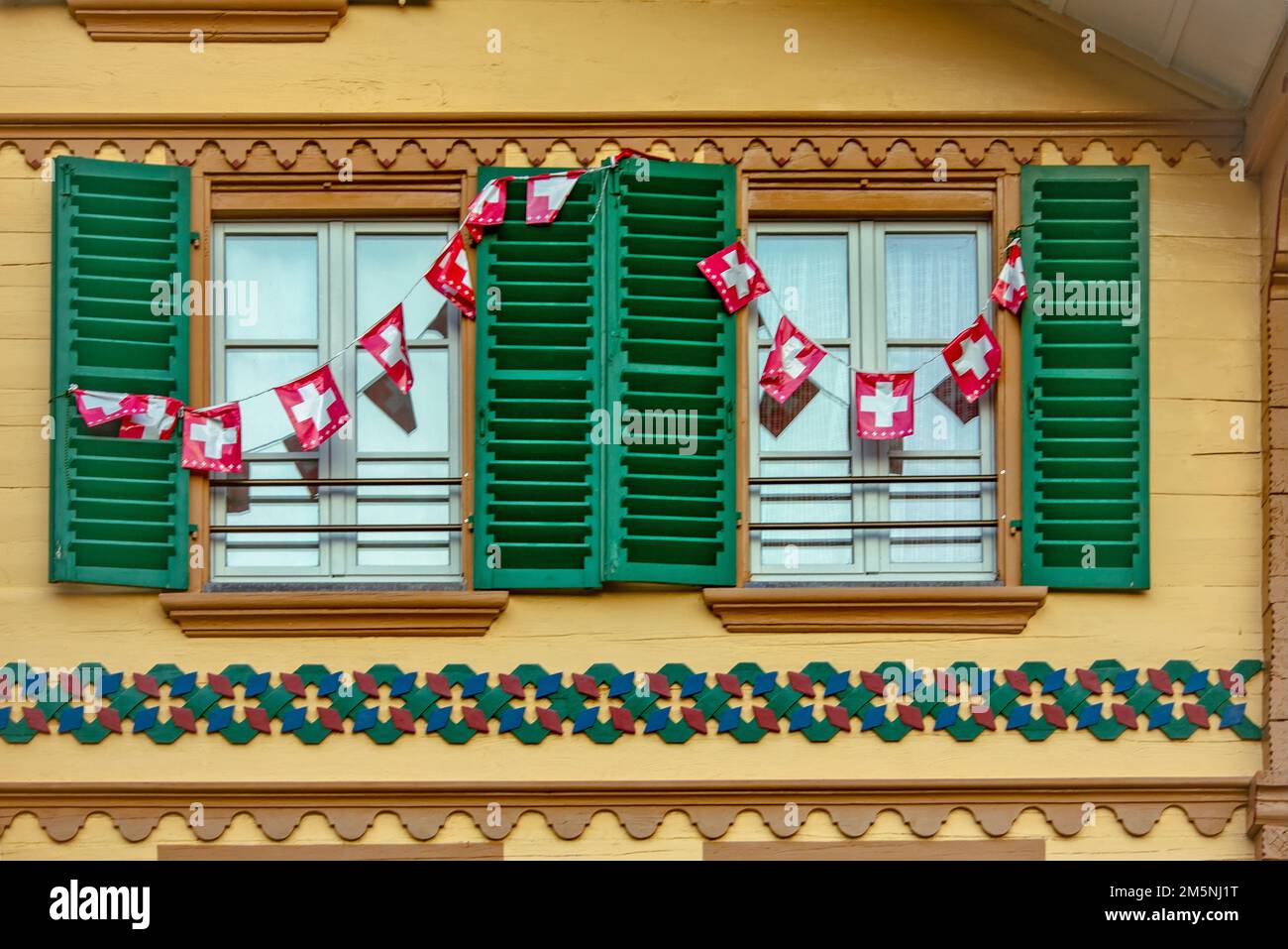 Old traditional wooden window with Switzerland flags Stock Photo - Alamy