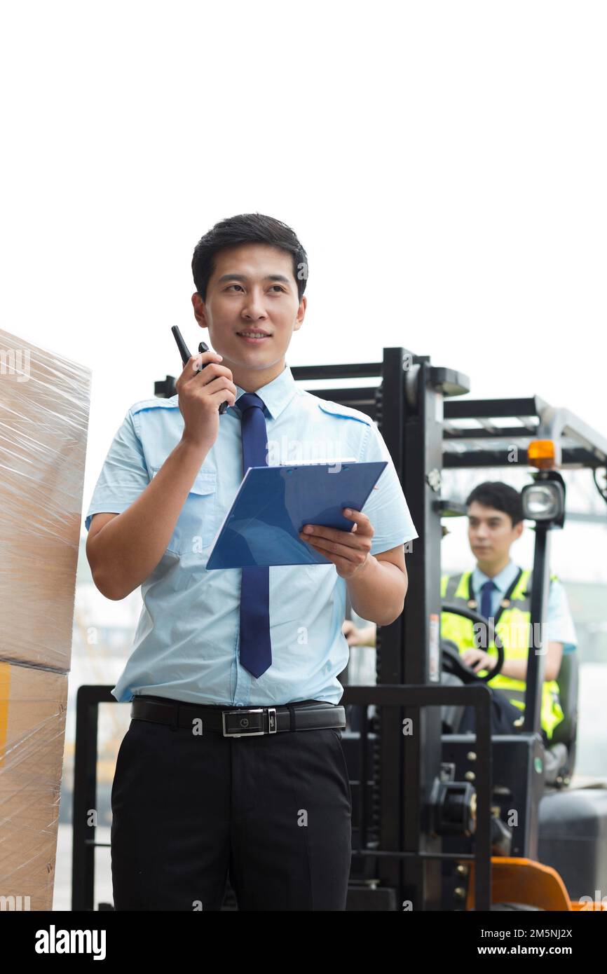 Logistics warehouse management personnel with interphone Stock Photo ...
