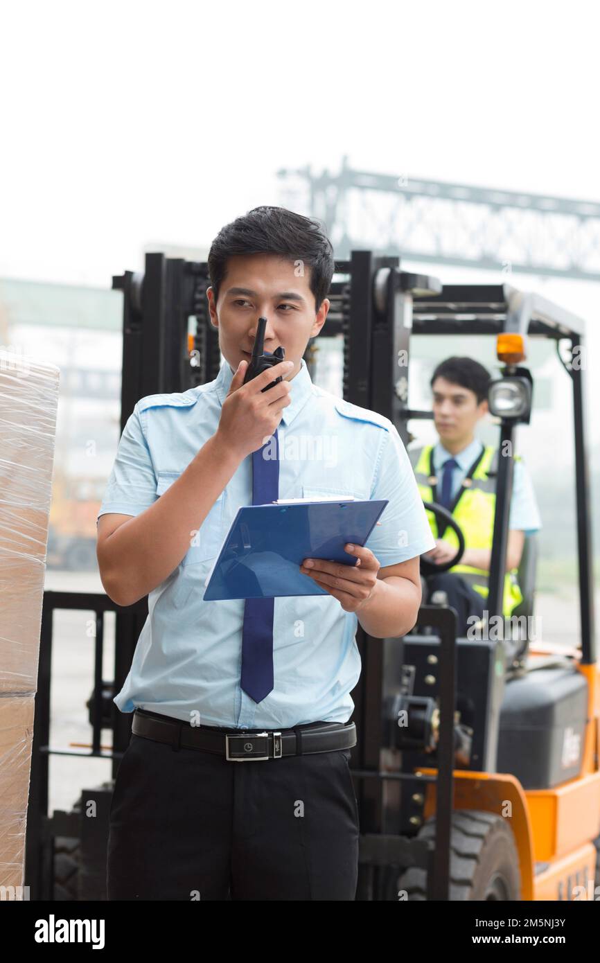Logistics warehouse management personnel with interphone Stock Photo ...