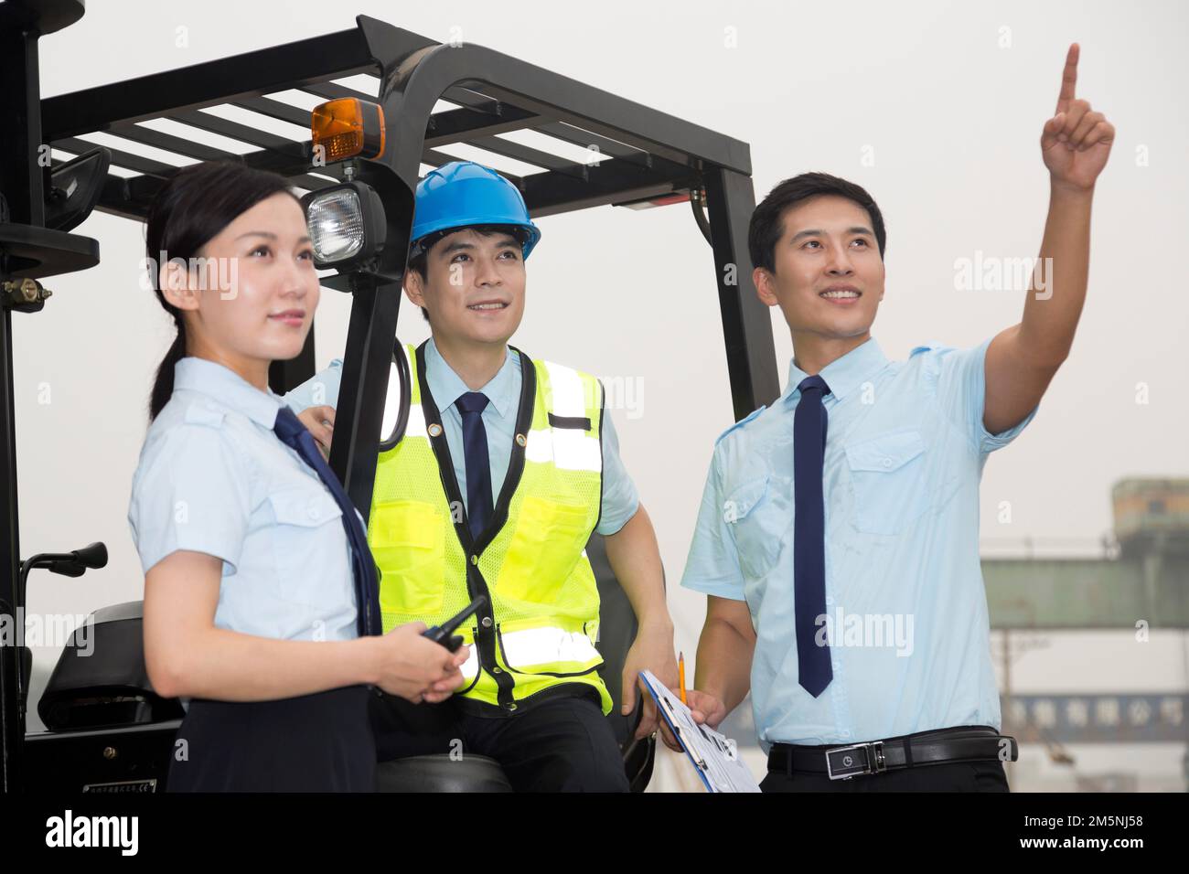 Logistics warehouse management personnel communicate with driving a ...