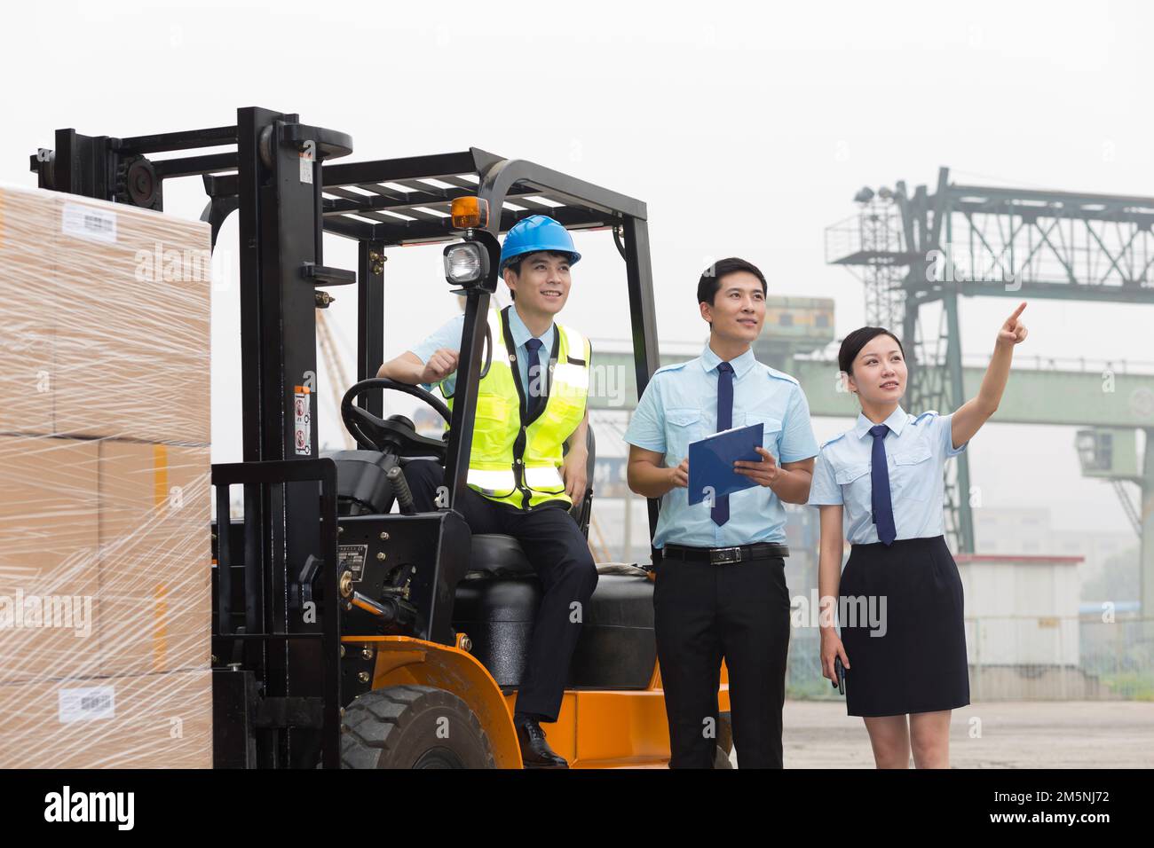 Logistics warehouse management personnel communicate with driving a ...