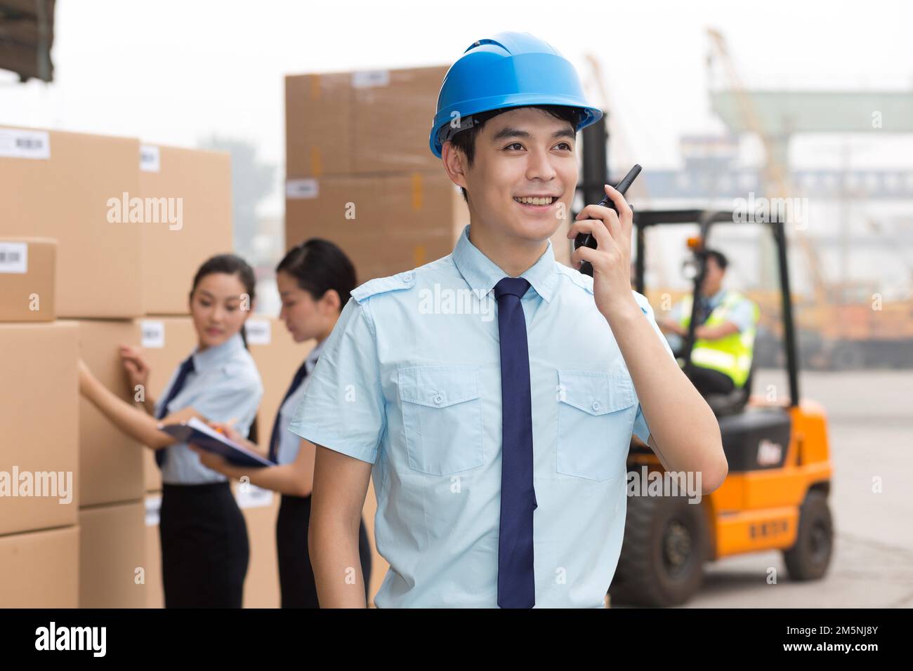 Logistics warehouse management personnel with interphone Stock Photo ...