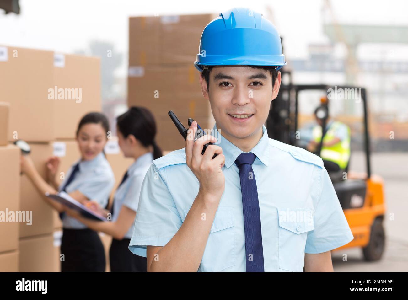 Logistics warehouse management personnel with interphone Stock Photo ...