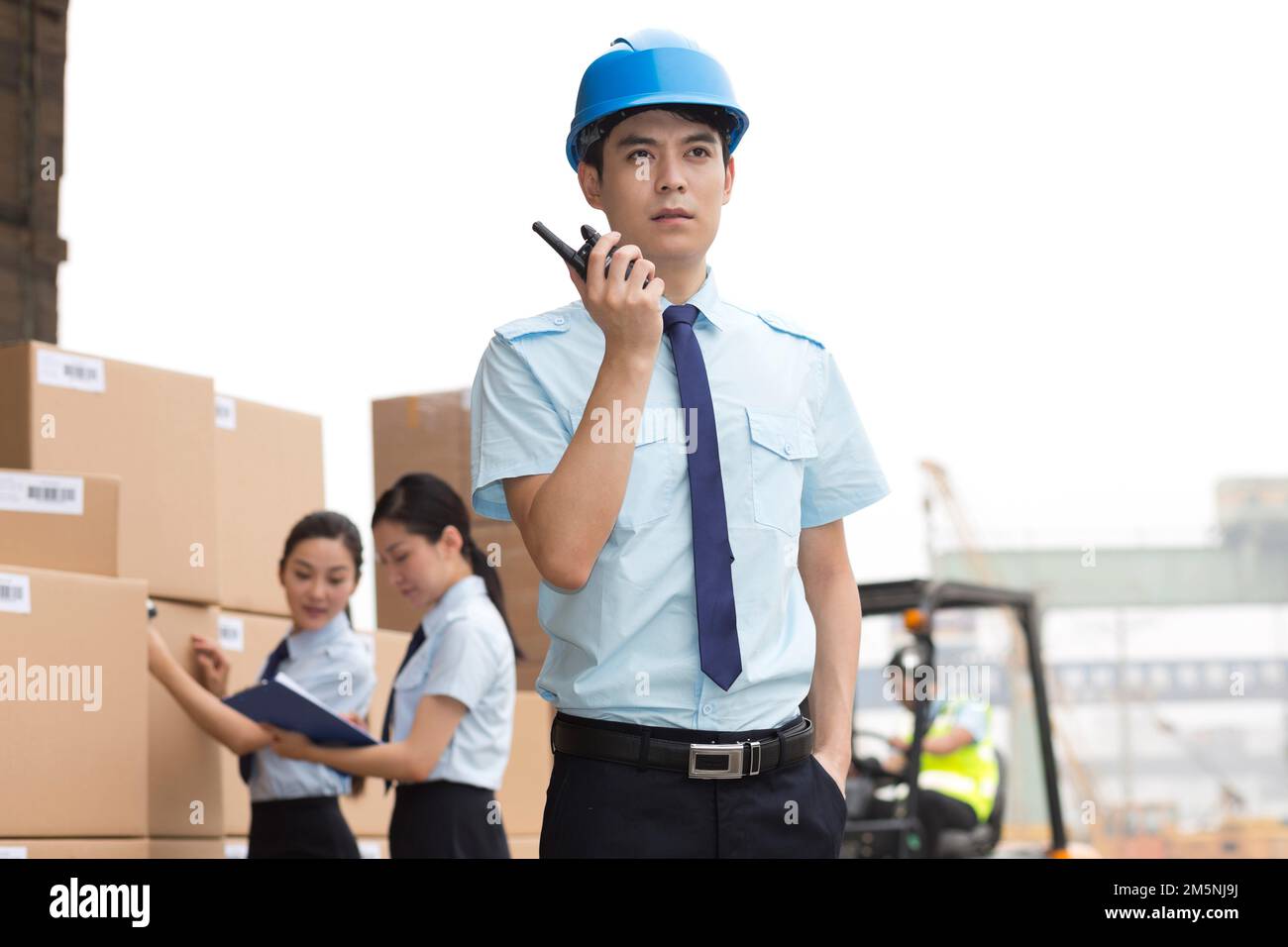 Logistics warehouse management personnel with interphone Stock Photo ...