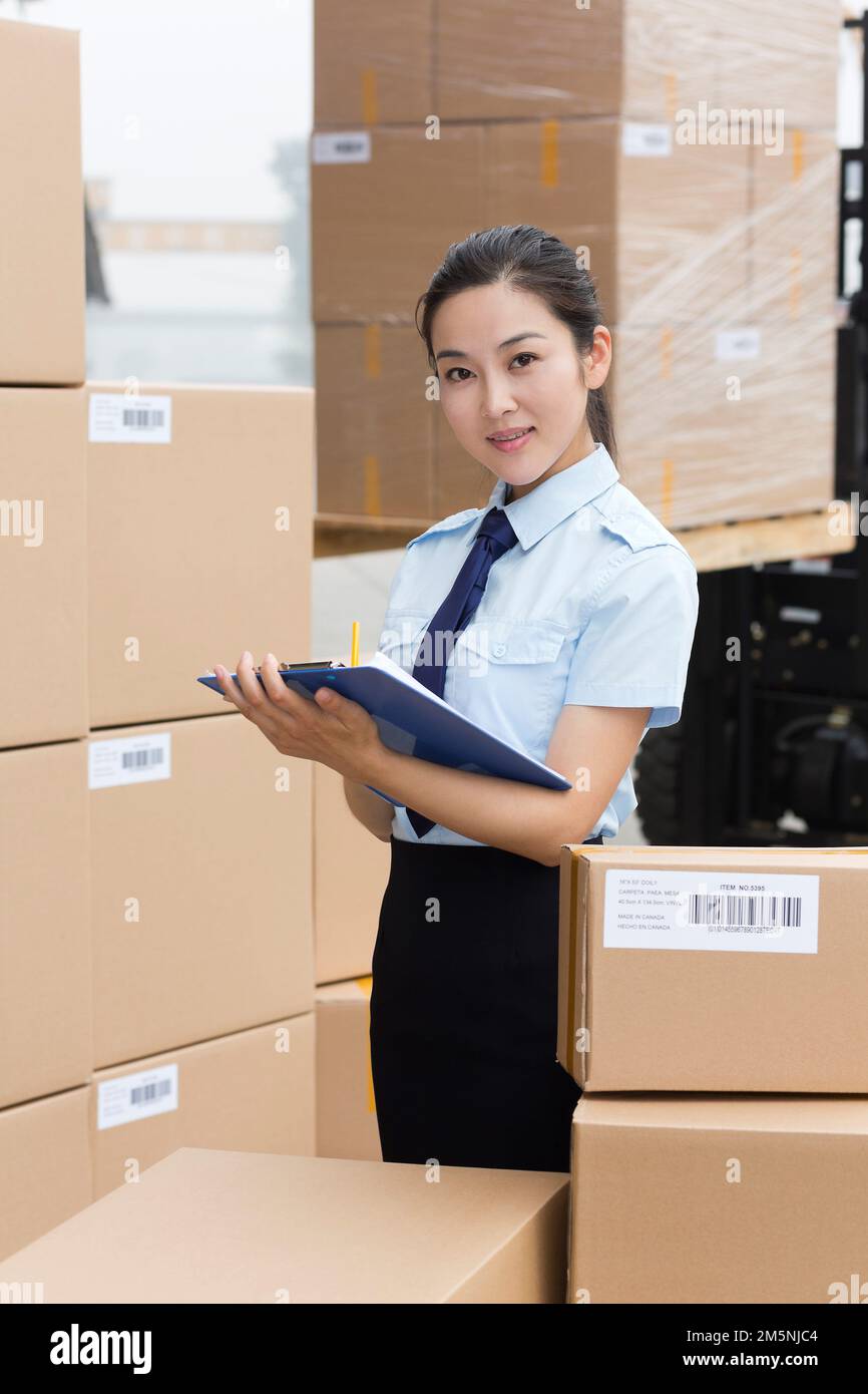 Logistics warehouse management personnel to check the goods Stock Photo ...
