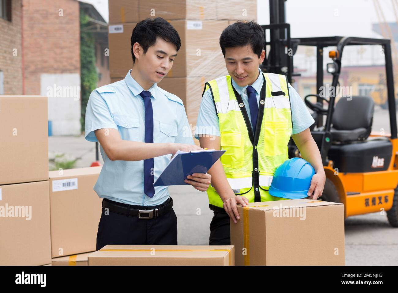 Logistics warehouse management personnel in communication Stock Photo ...