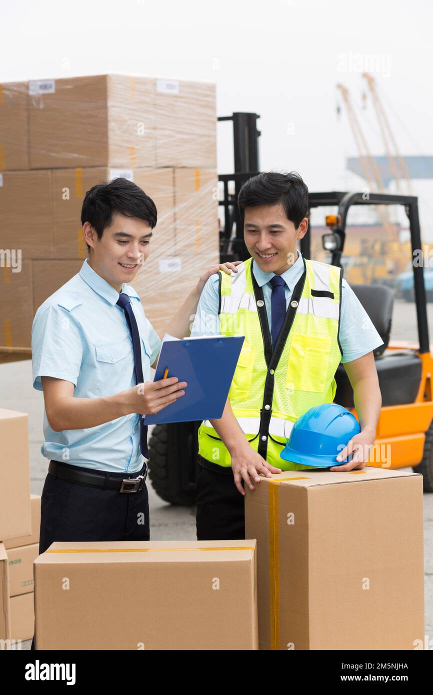 Logistics warehouse management personnel in communication Stock Photo ...