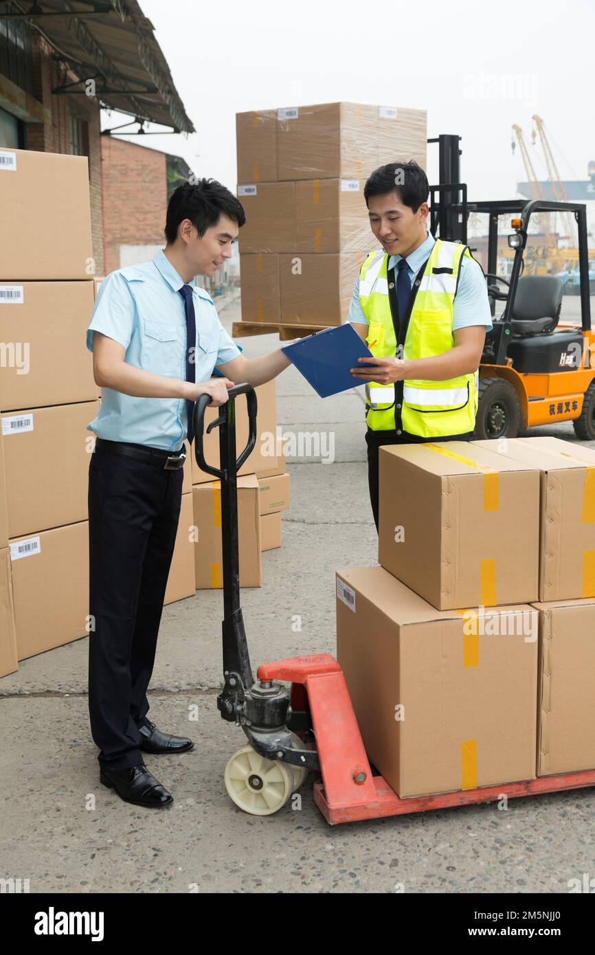 Logistics warehouse management personnel to check the goods Stock Photo ...
