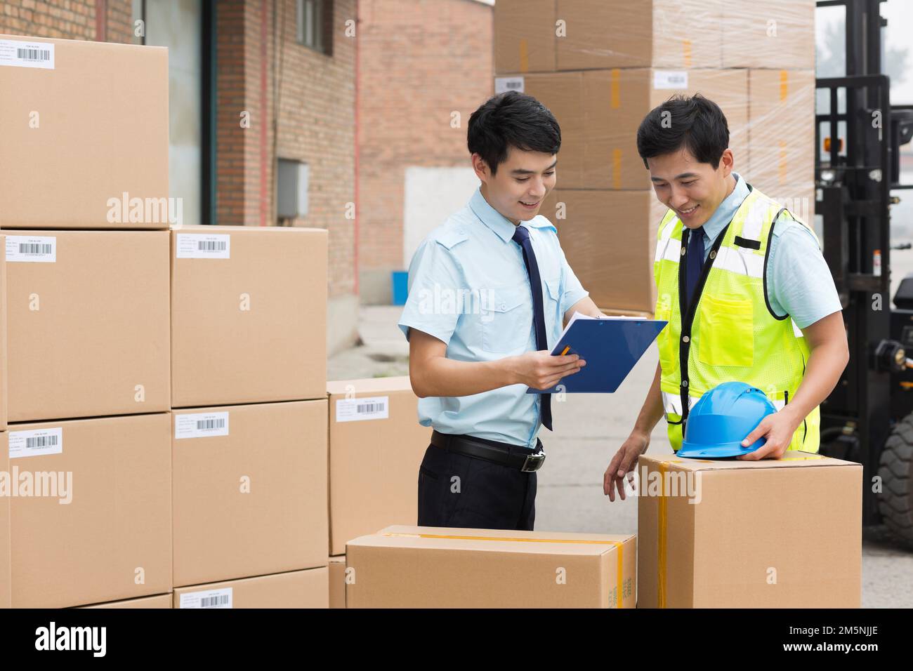 Logistics warehouse management personnel in communication Stock Photo ...