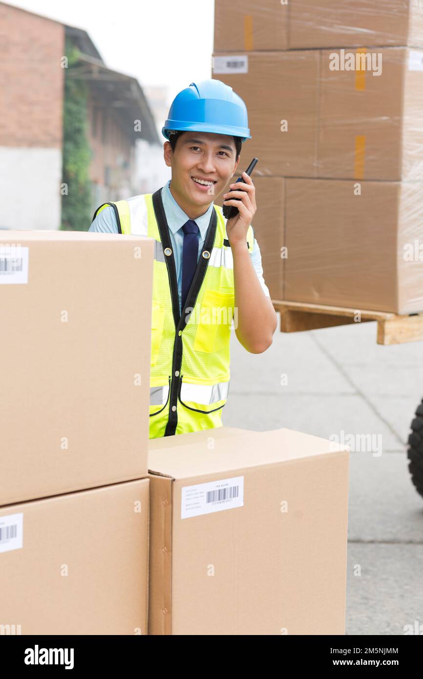 Logistics warehouse management personnel with interphone Stock Photo ...