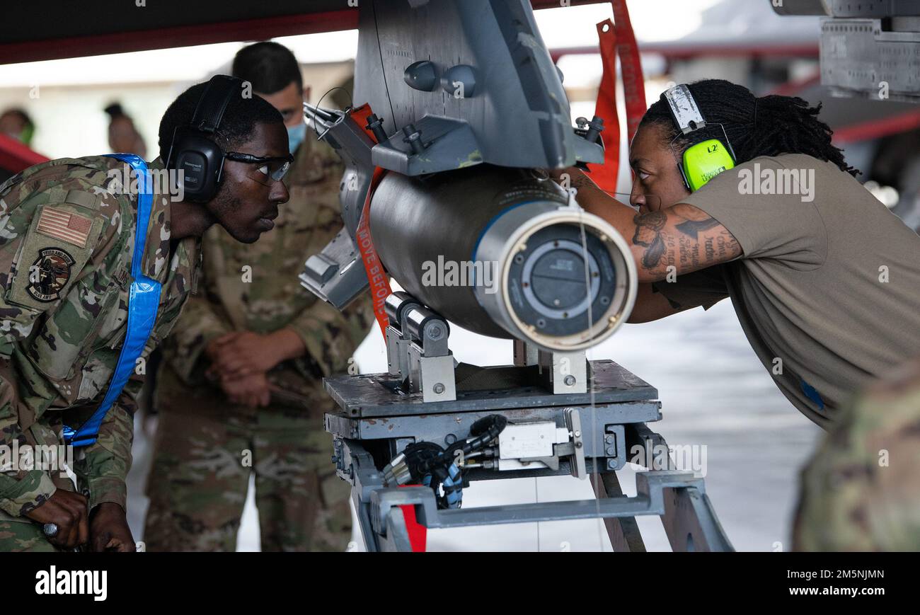 A 96th Aircraft Maintenance Squadron Blue team secures a GBU-12 onto an ...