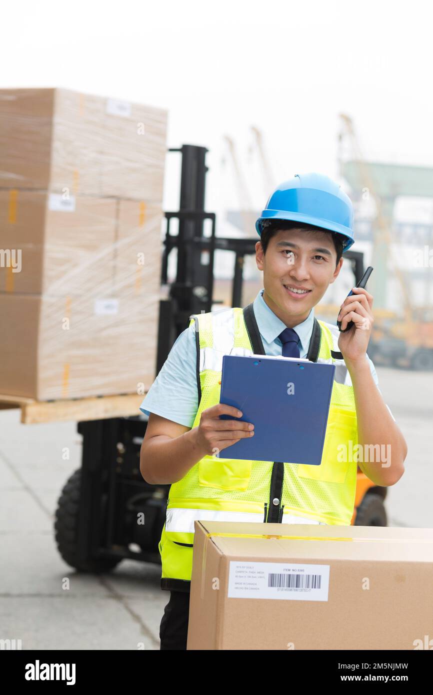 Logistics warehouse management personnel with interphone Stock Photo ...