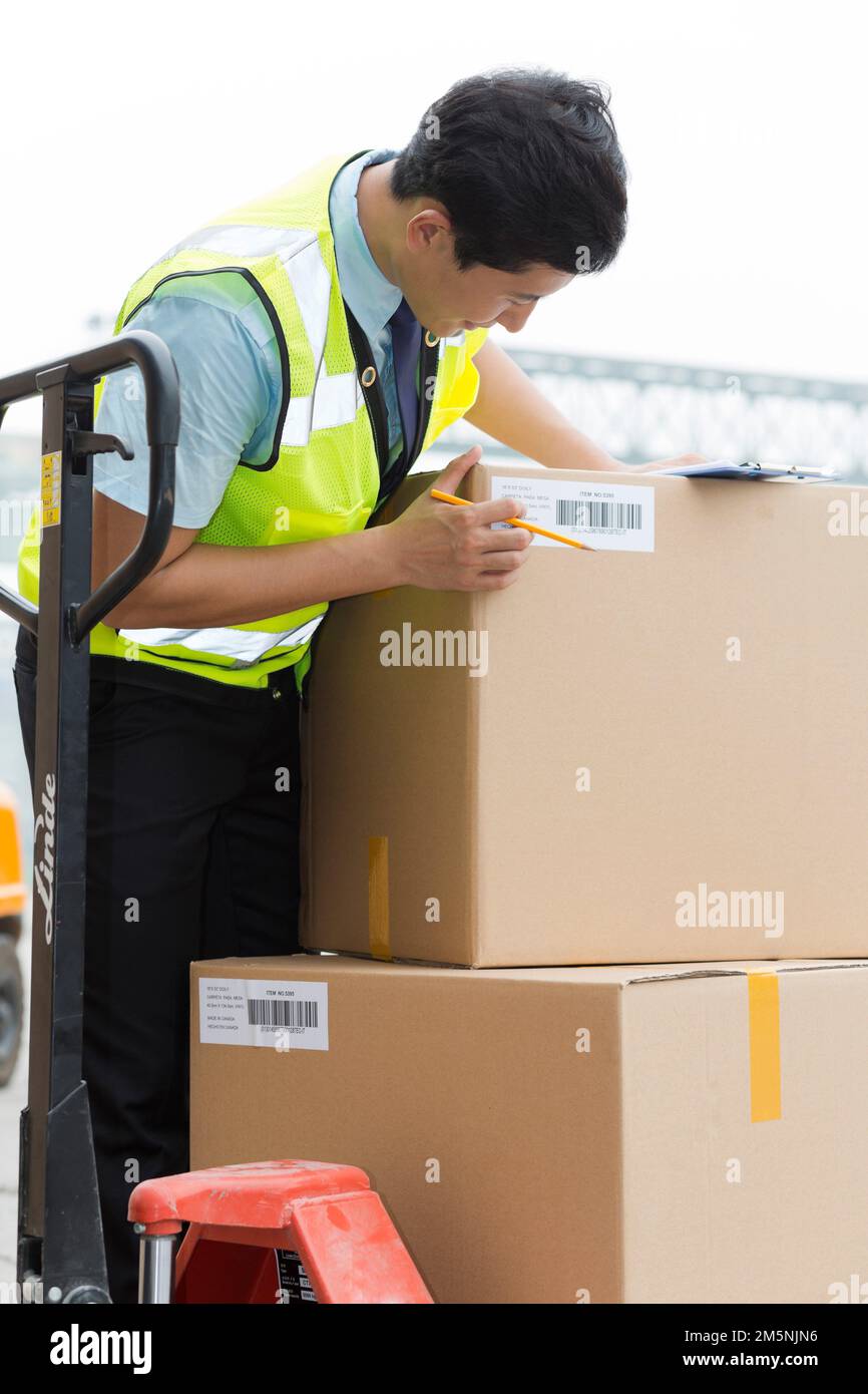 Logistics warehouse management personnel to check the goods Stock Photo ...