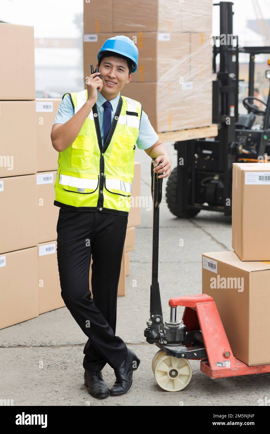 Logistics warehouse management personnel with interphone Stock Photo ...