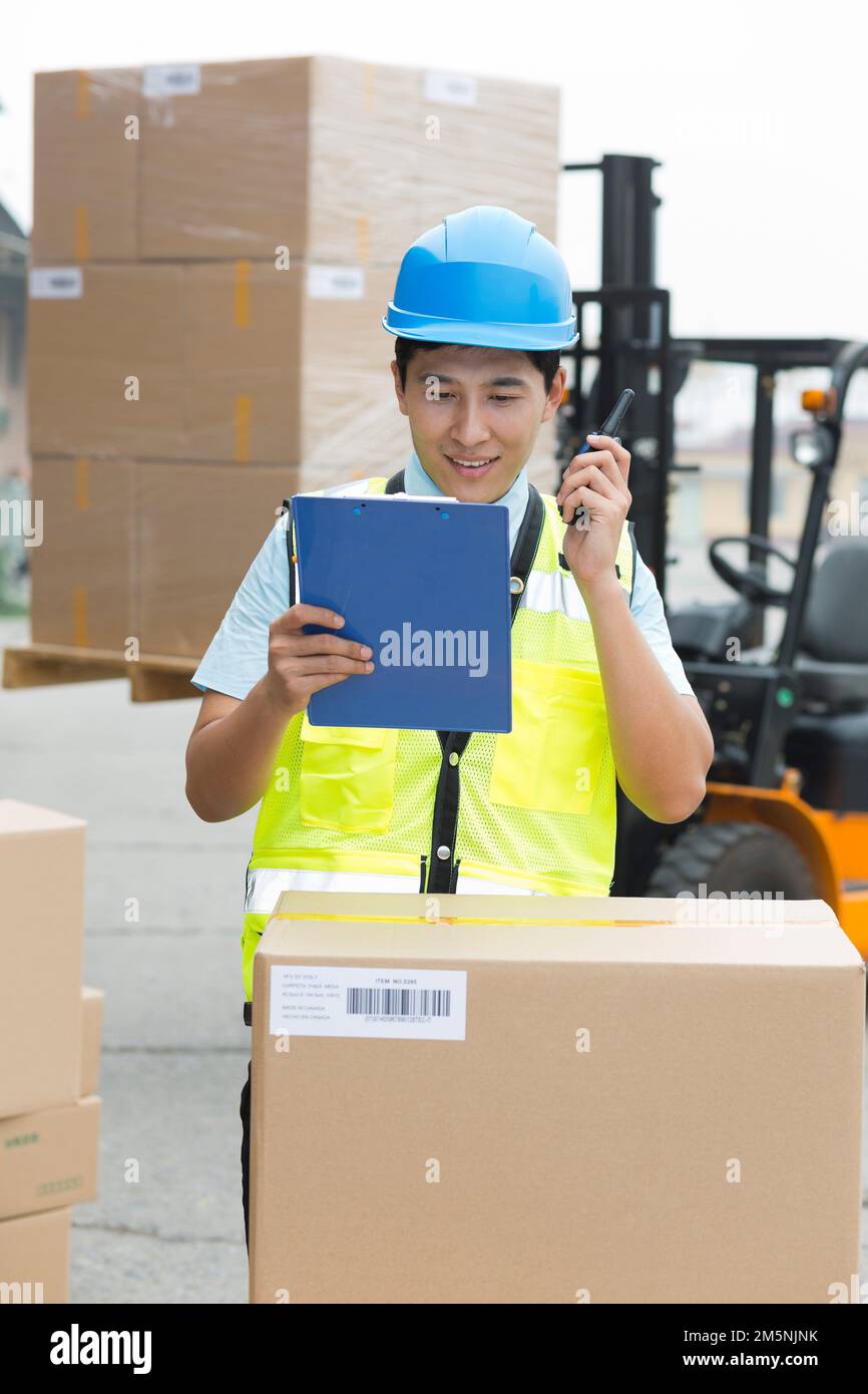 Logistics warehouse management personnel with interphone Stock Photo ...