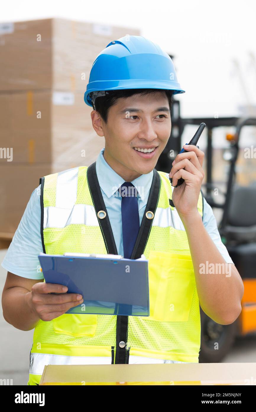 Logistics warehouse management personnel with interphone Stock Photo ...
