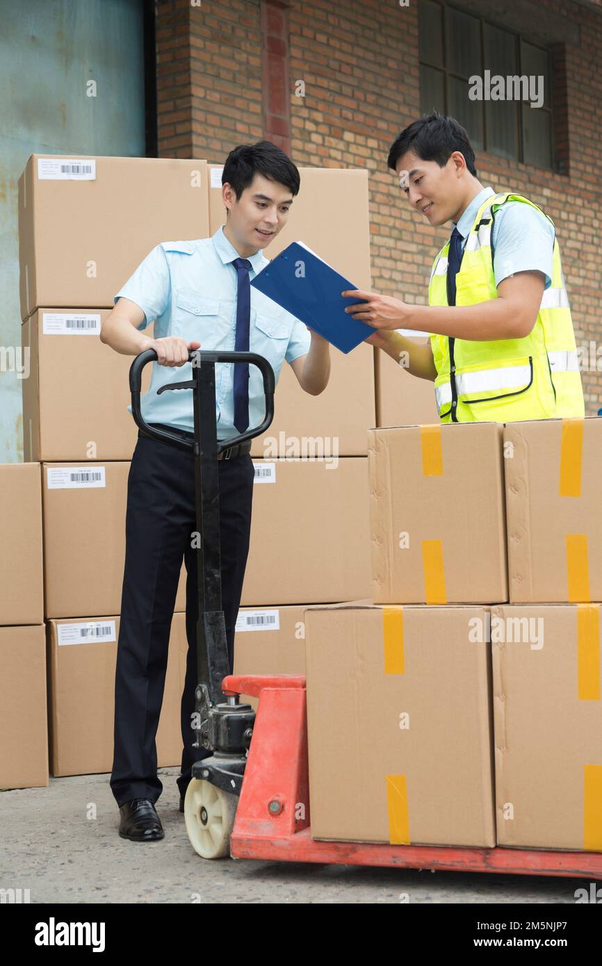 Logistics warehouse management personnel to check the goods Stock Photo ...