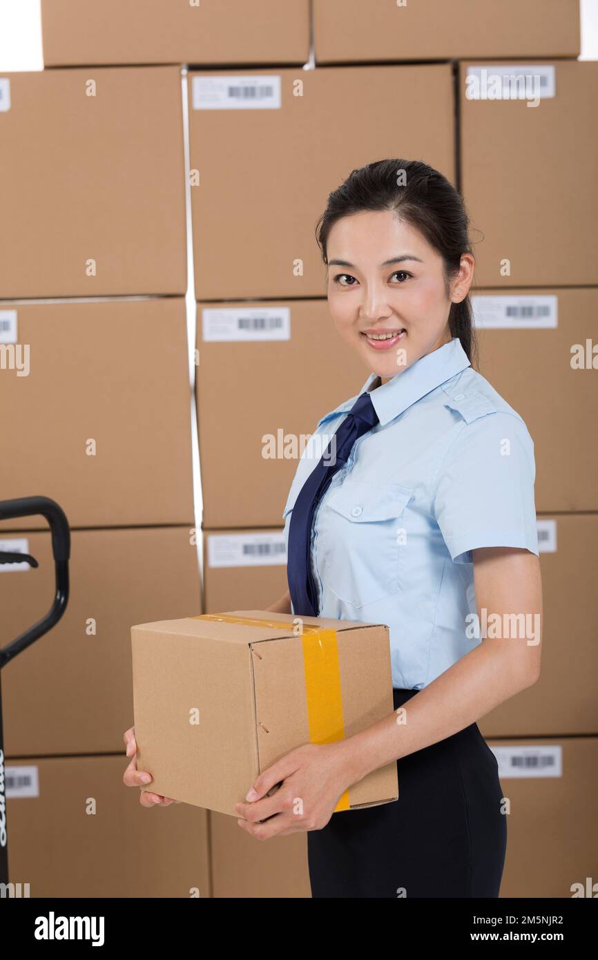 Logistics warehouse staff holding the carton Stock Photo - Alamy