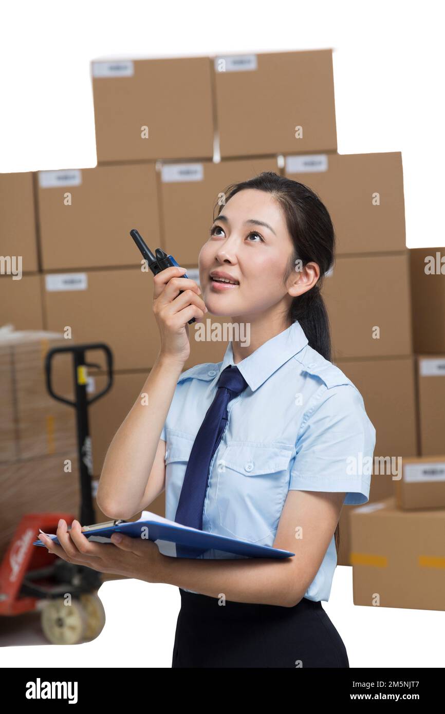 Logistics warehouse staff hand interphone Stock Photo - Alamy