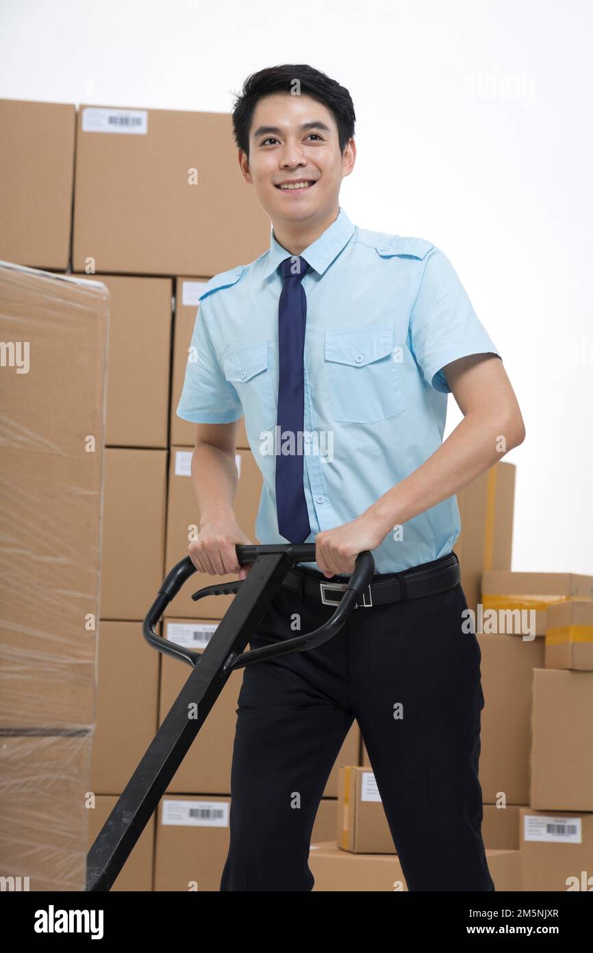 Trolley freight logistics warehouse staff Stock Photo - Alamy