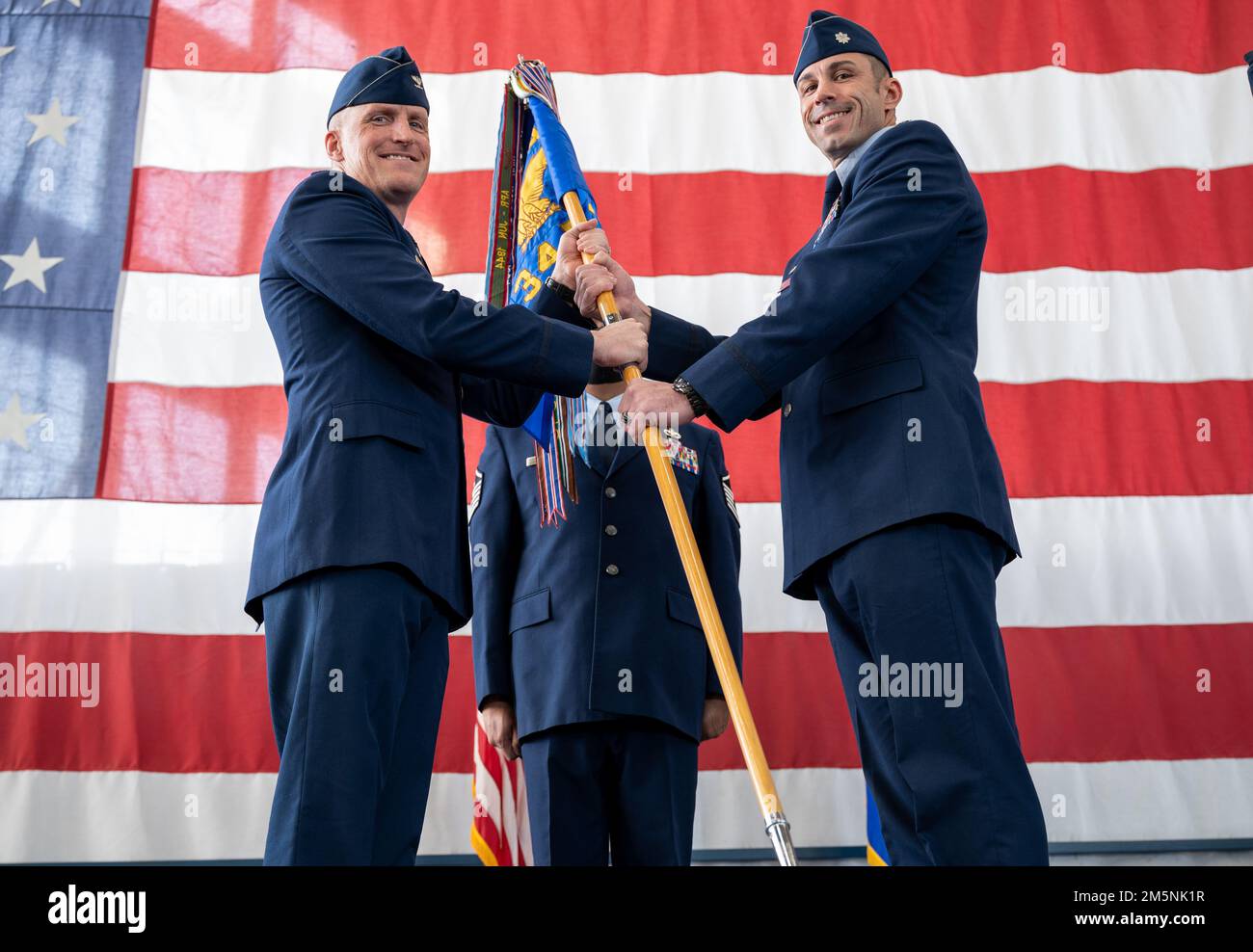 Col. Derek Oakley, 28th Operations Group commander, left, presents the 34th Bomb Squadron guidon ...
