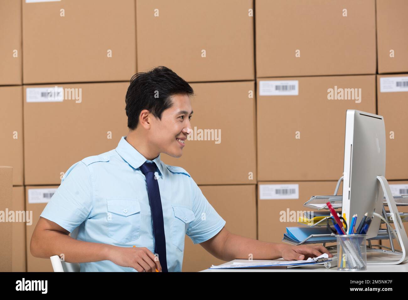 Logistics warehouse staff use office computer Stock Photo - Alamy
