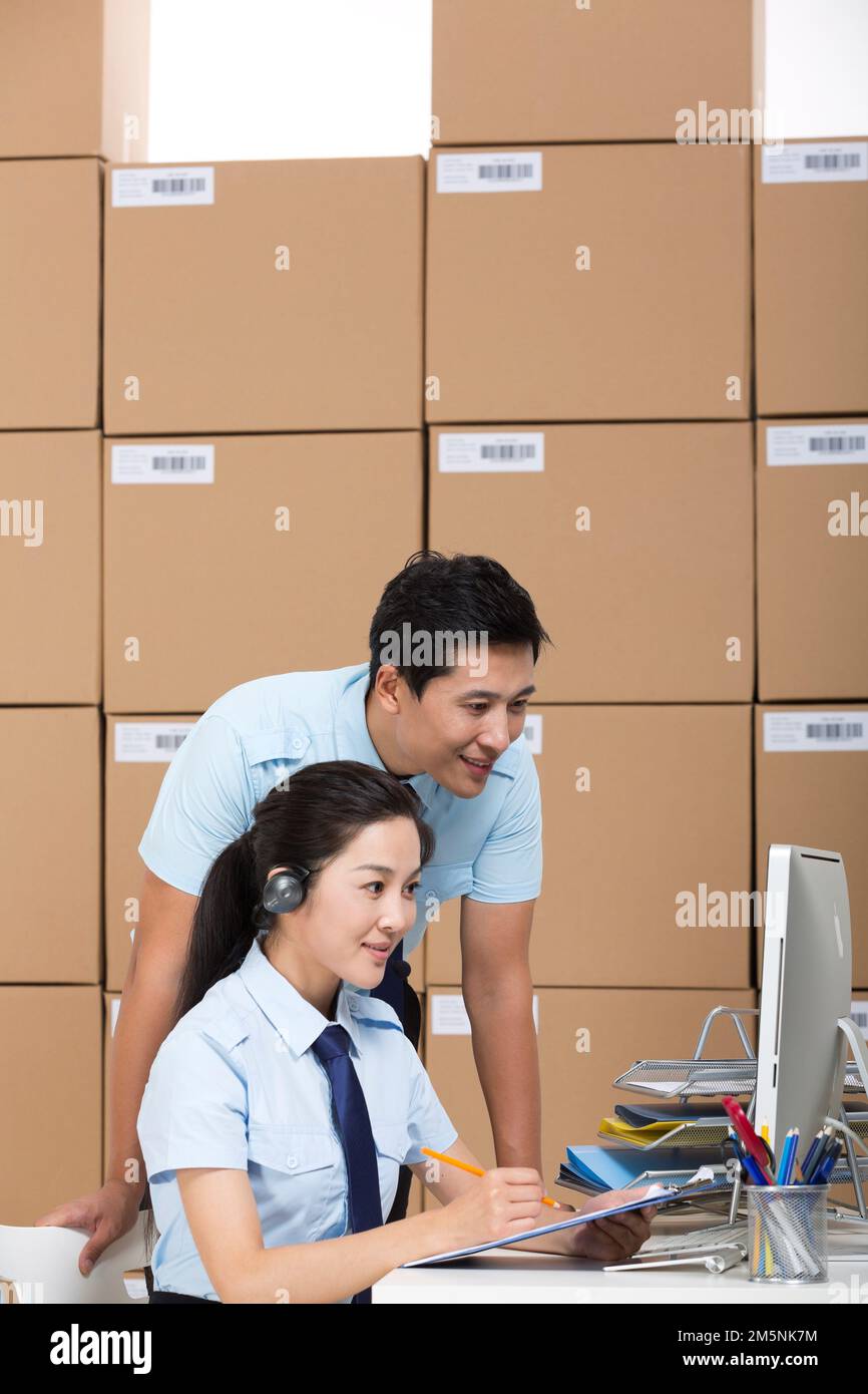 Logistics warehouse staff use office computer Stock Photo - Alamy